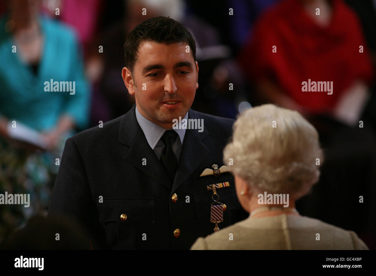 Flight Lieutenant Kevin Harris, Royal Air Force, is decorated with the ...
