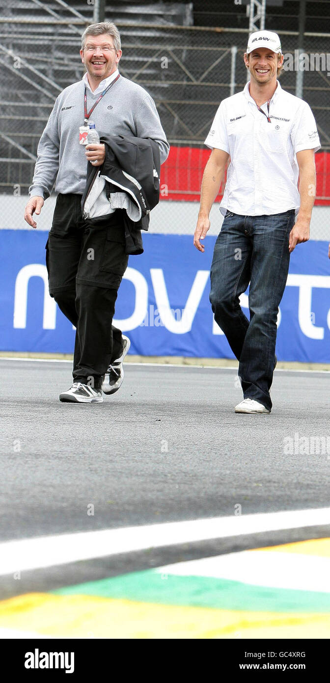 Brawn GP's Jenson Button (right) takes a walk around the track with ...