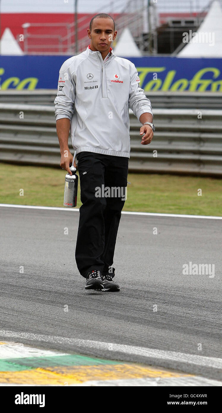 Mclaren's Lewis Hamilton takes a walk around the track at Interlagos ...