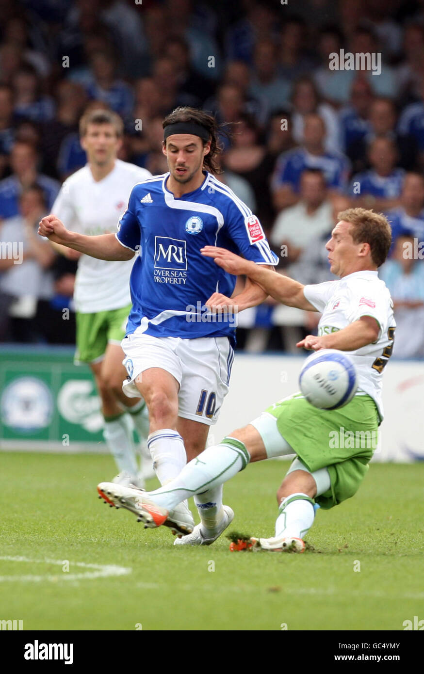 Peterborough United's George Boyd tussels with Reading's Brian Howard ...