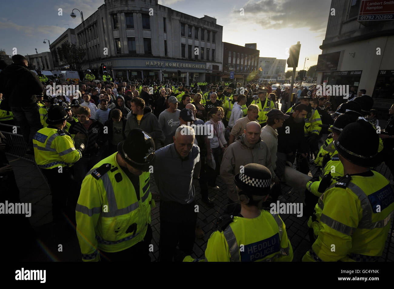Welsh Defence League protesters are closely followed by police as their ...