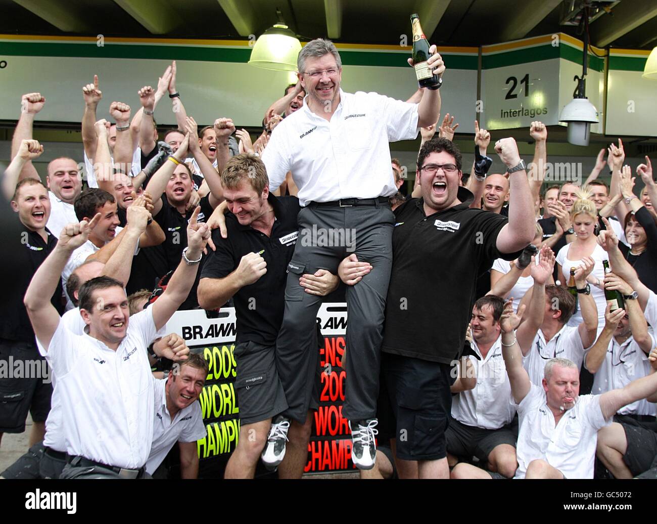 Brawn GP team principal Ross Brawn is lifted by the crew as Brawn ...