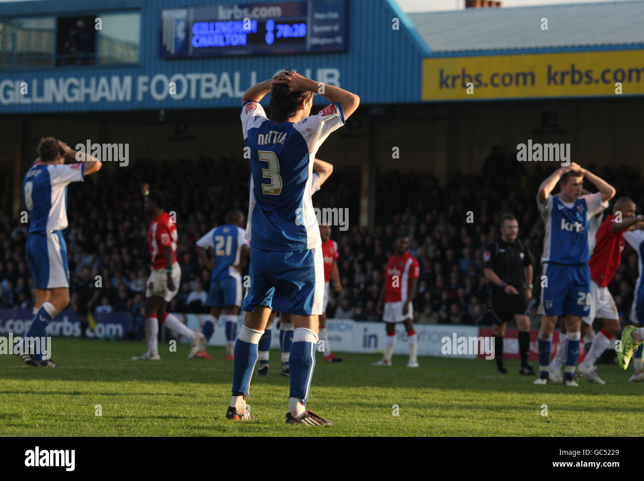 Gillingham's John Nutter (centre) holds his head after scoring an own ...