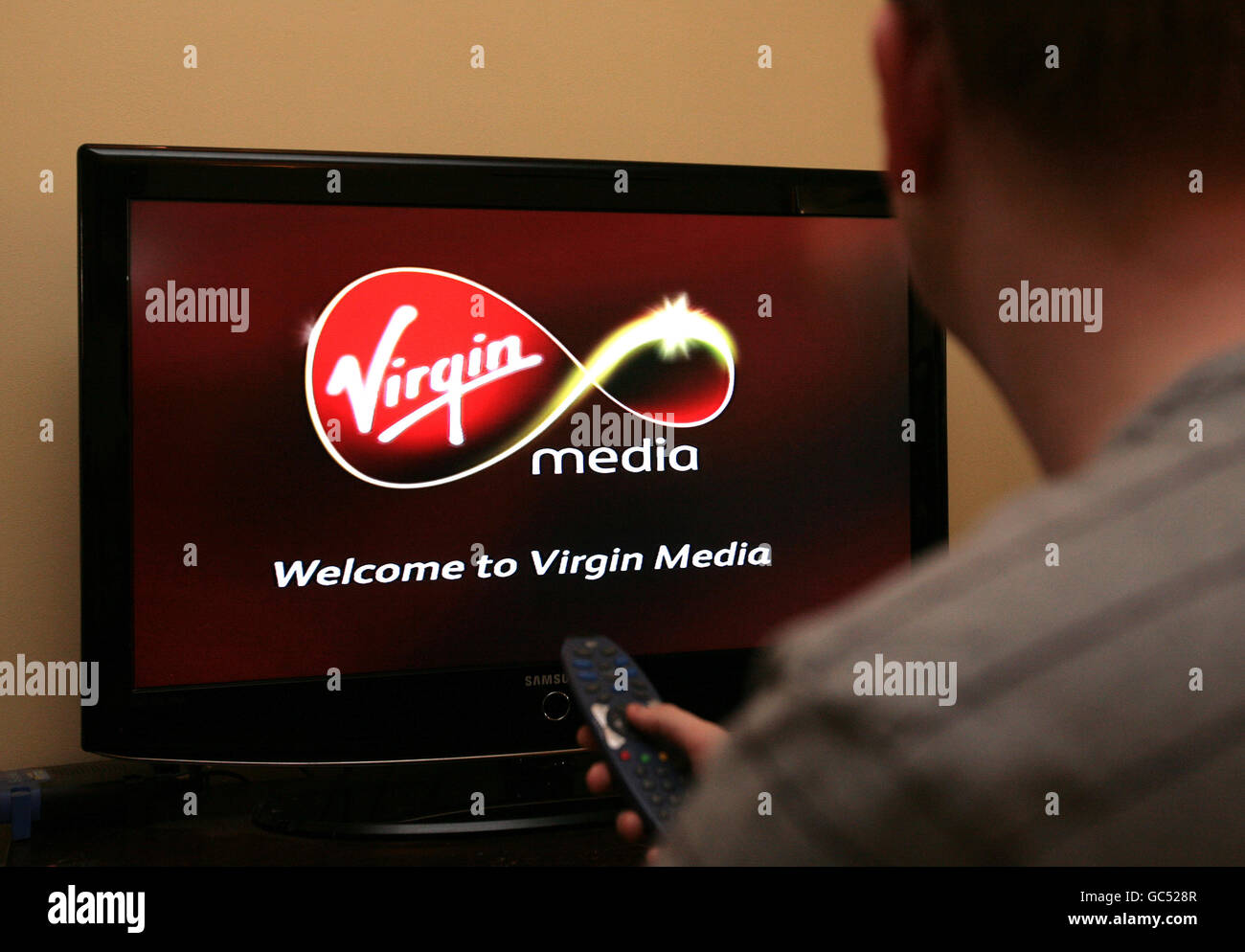 Man looks at virgin media welcome screen on television hi-res stock ...