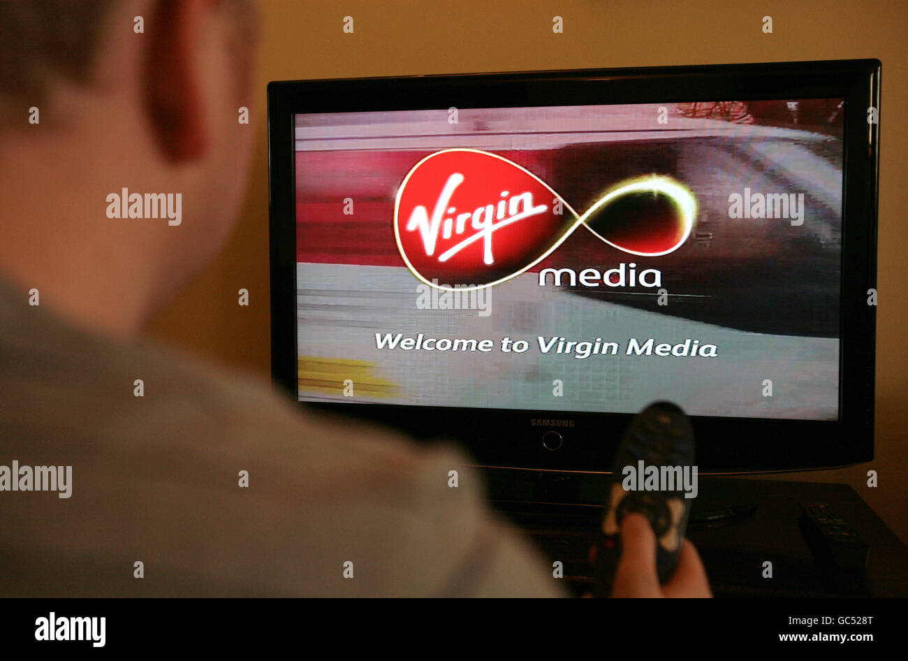 Man looks at virgin media welcome screen on television hi-res stock ...