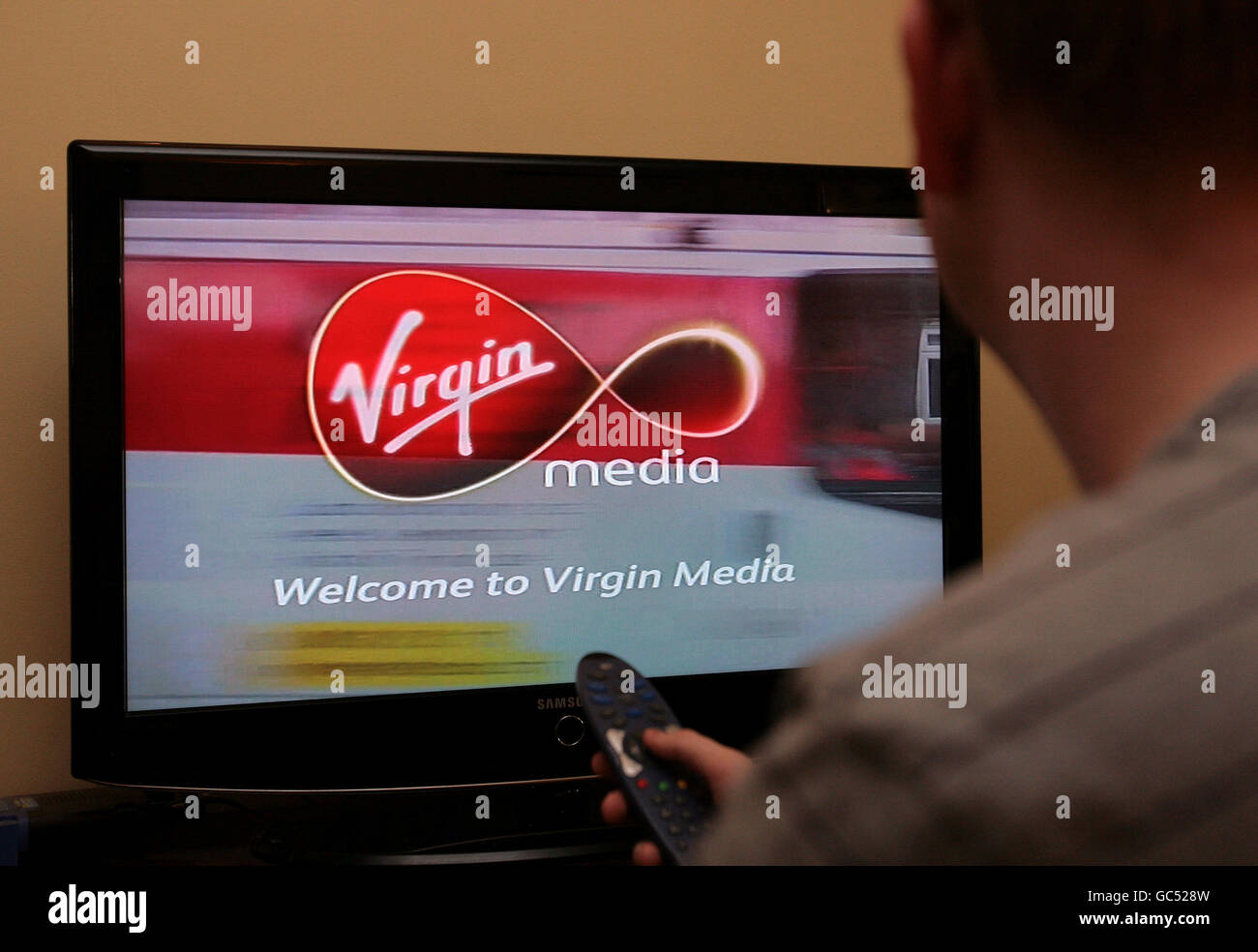 Man looks at virgin media welcome screen on television hi-res stock ...