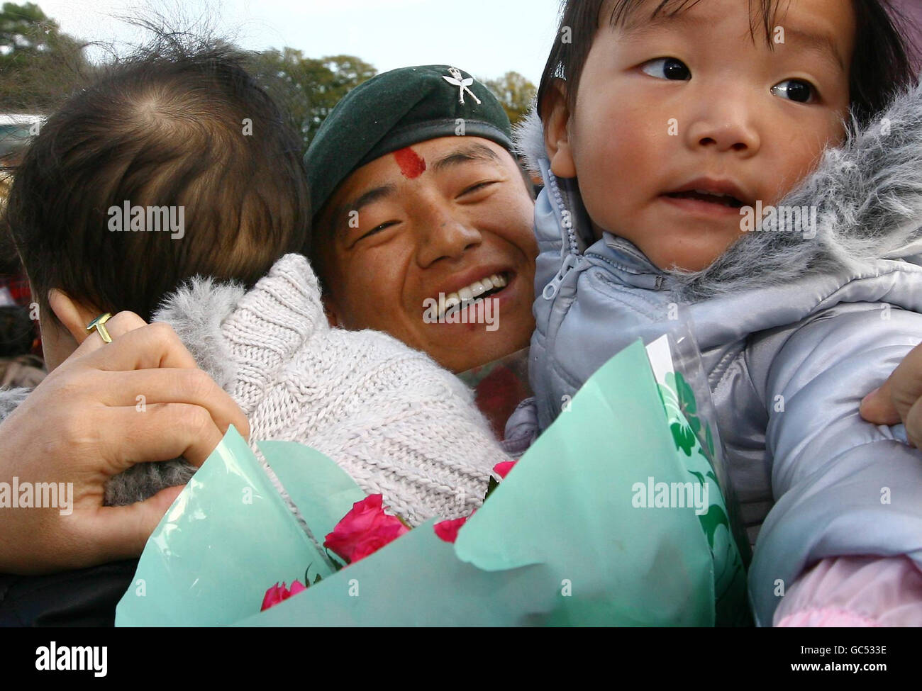 Suman Rai hugs his children Omh Hang (left) and Divya (right) as 25 ...