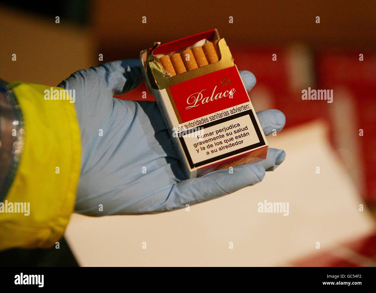 A Customs officer holds a packet of Palace cigarettes in Greenore Port ...