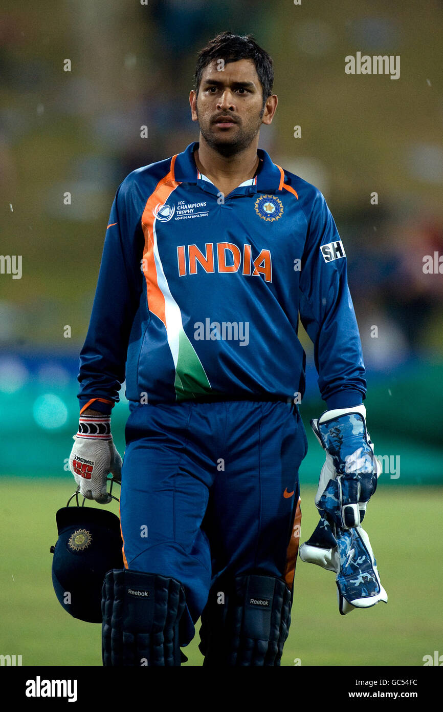 Indian captain MS Dhoni leaves the field as rain halts play during the ...