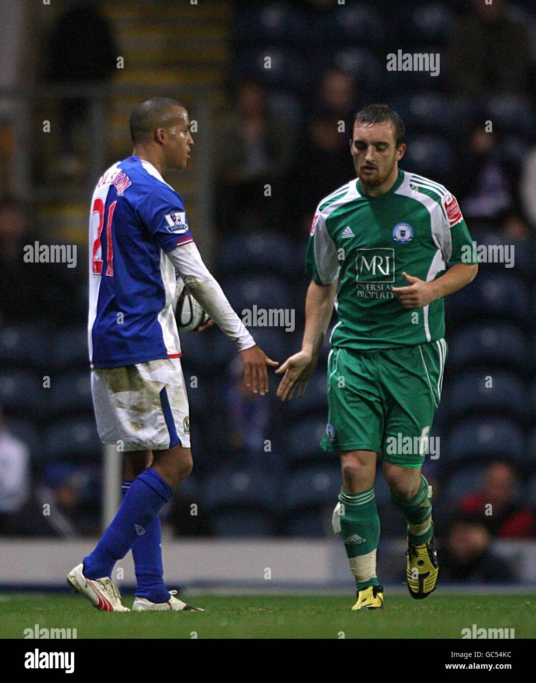 Peterborough United's Charlie Lee (right) shakes hands with Blackburn ...
