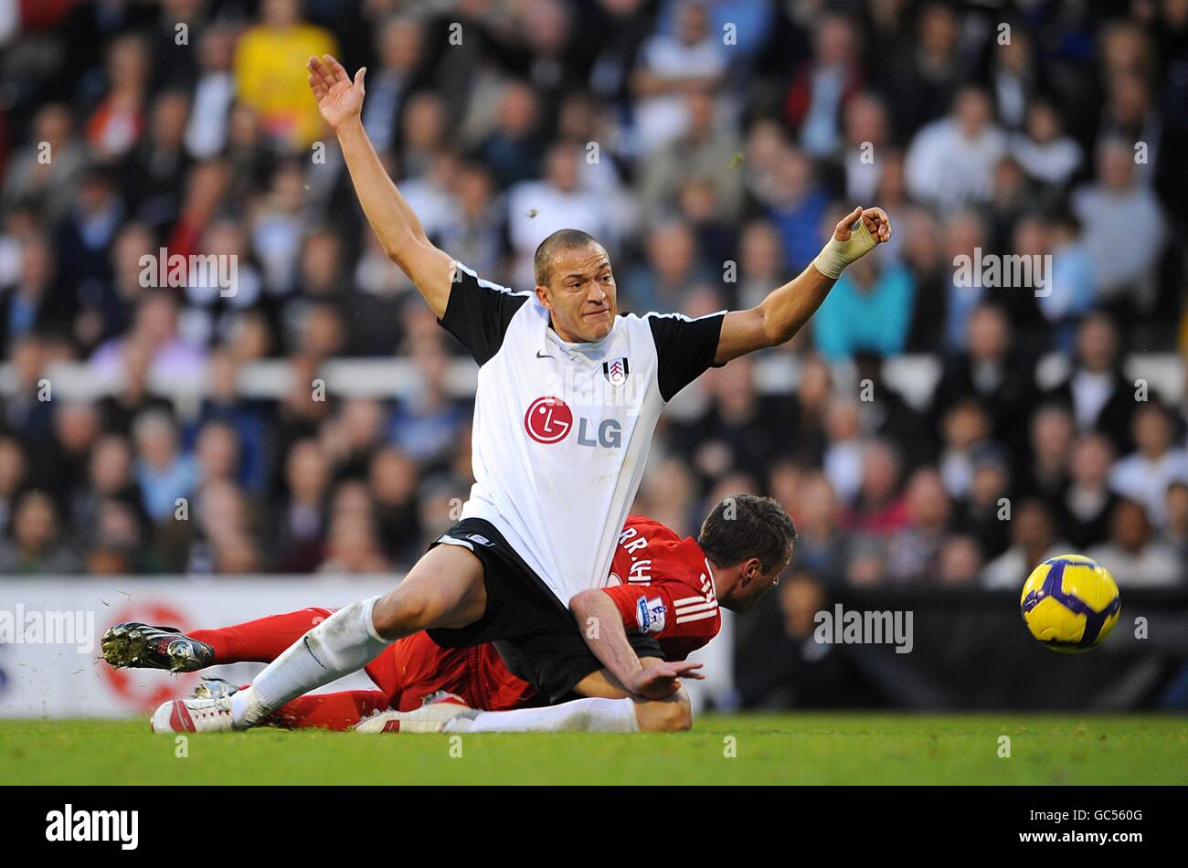Liverpool's Jamie Carragher brings down Fulham's Bobby Zamora who fails ...