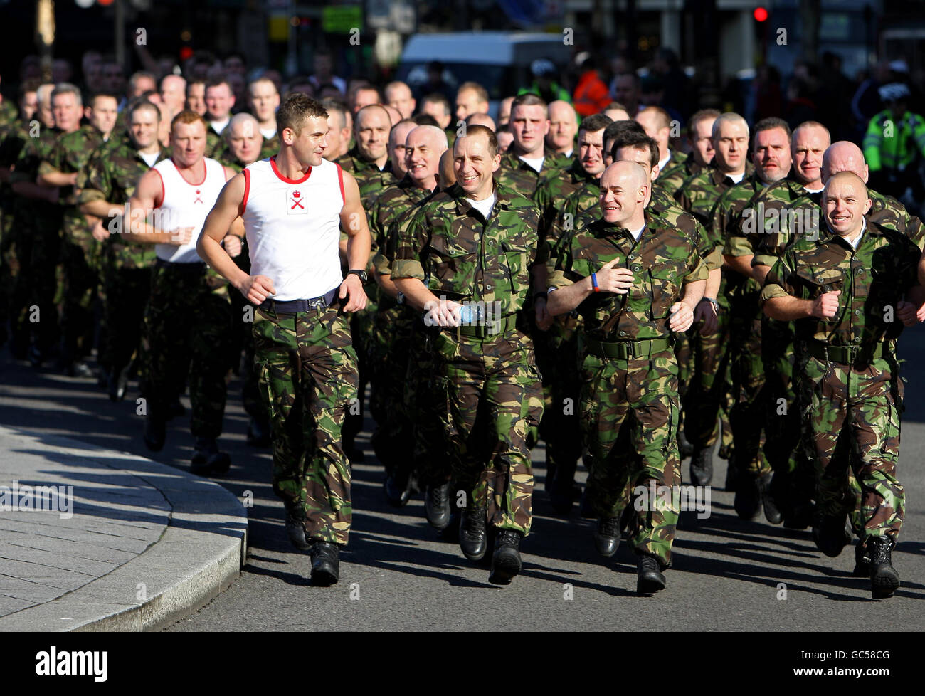 A group of around 90 former Royal Marines speed march through Trafalgar ...