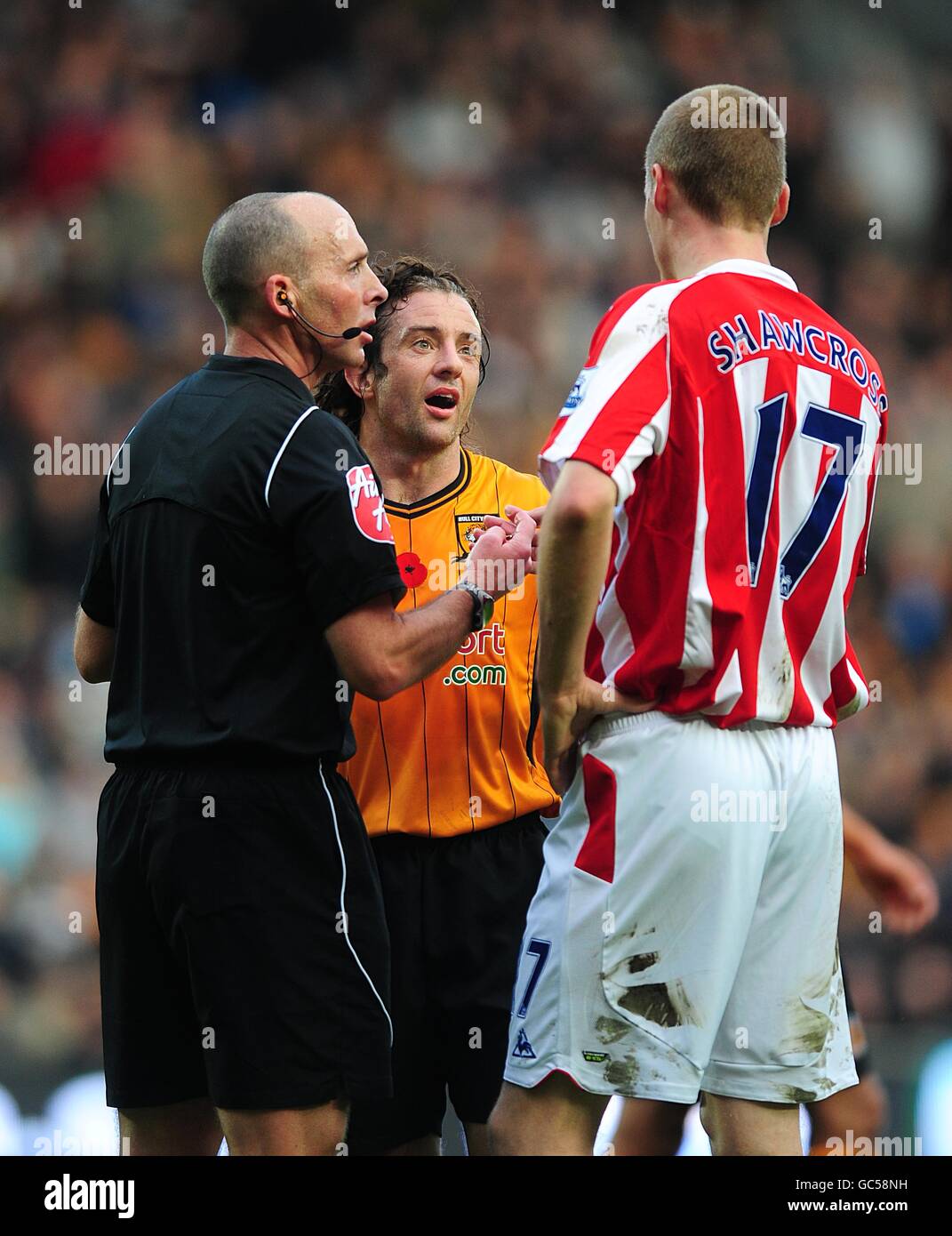 Referee Mike Dean has to intervene in a dispute between Hull City's ...
