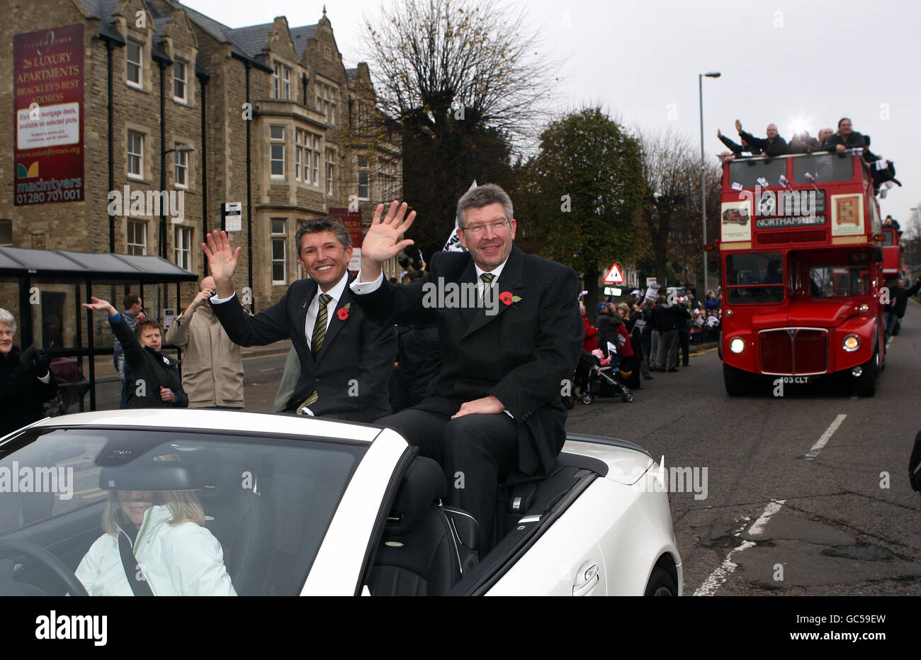 Nick Fry (left) and Ross Brawn acknowledge fans who turned out to ...
