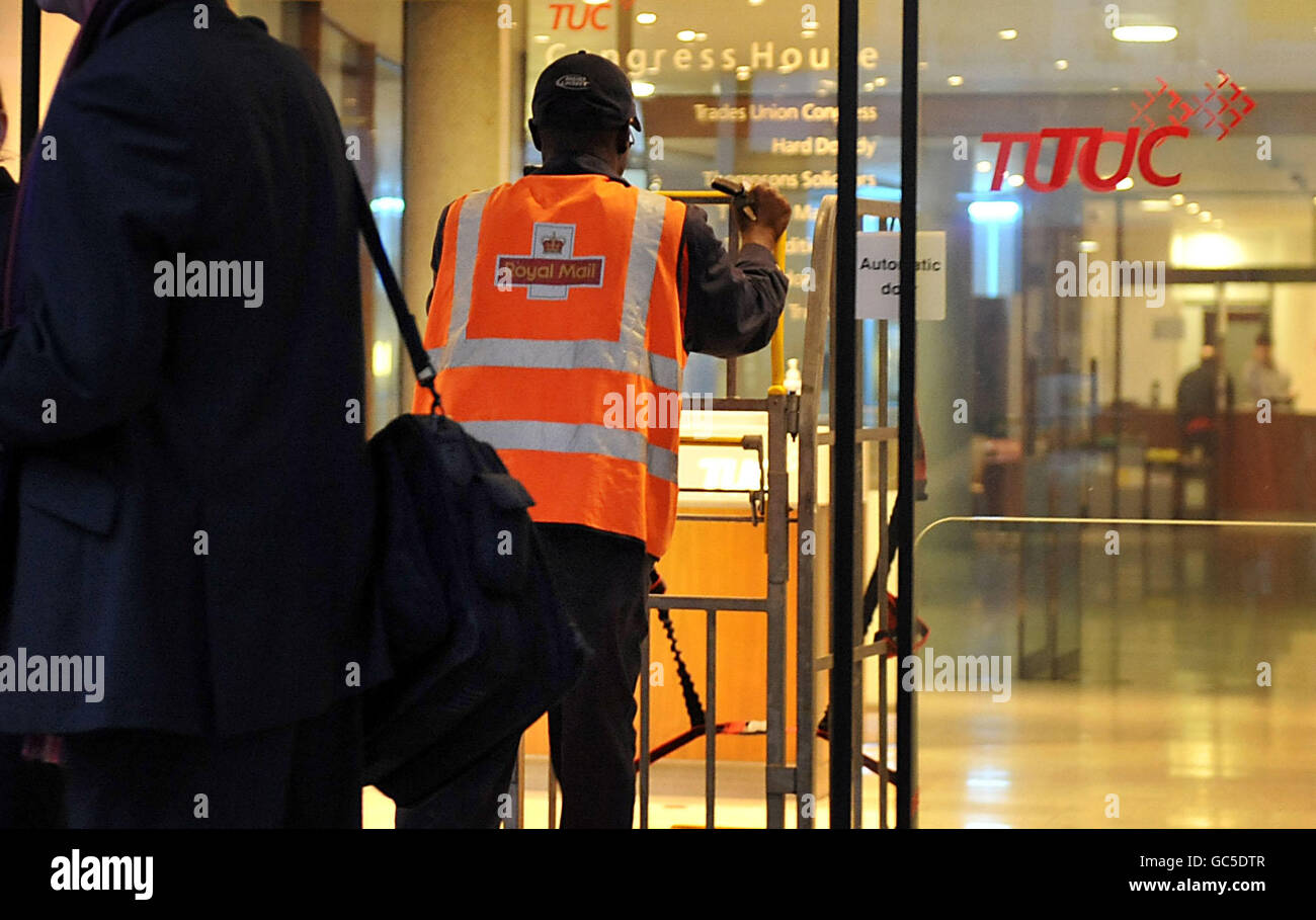 A Royal Mail worker leaves the TUC building in London after collecting ...