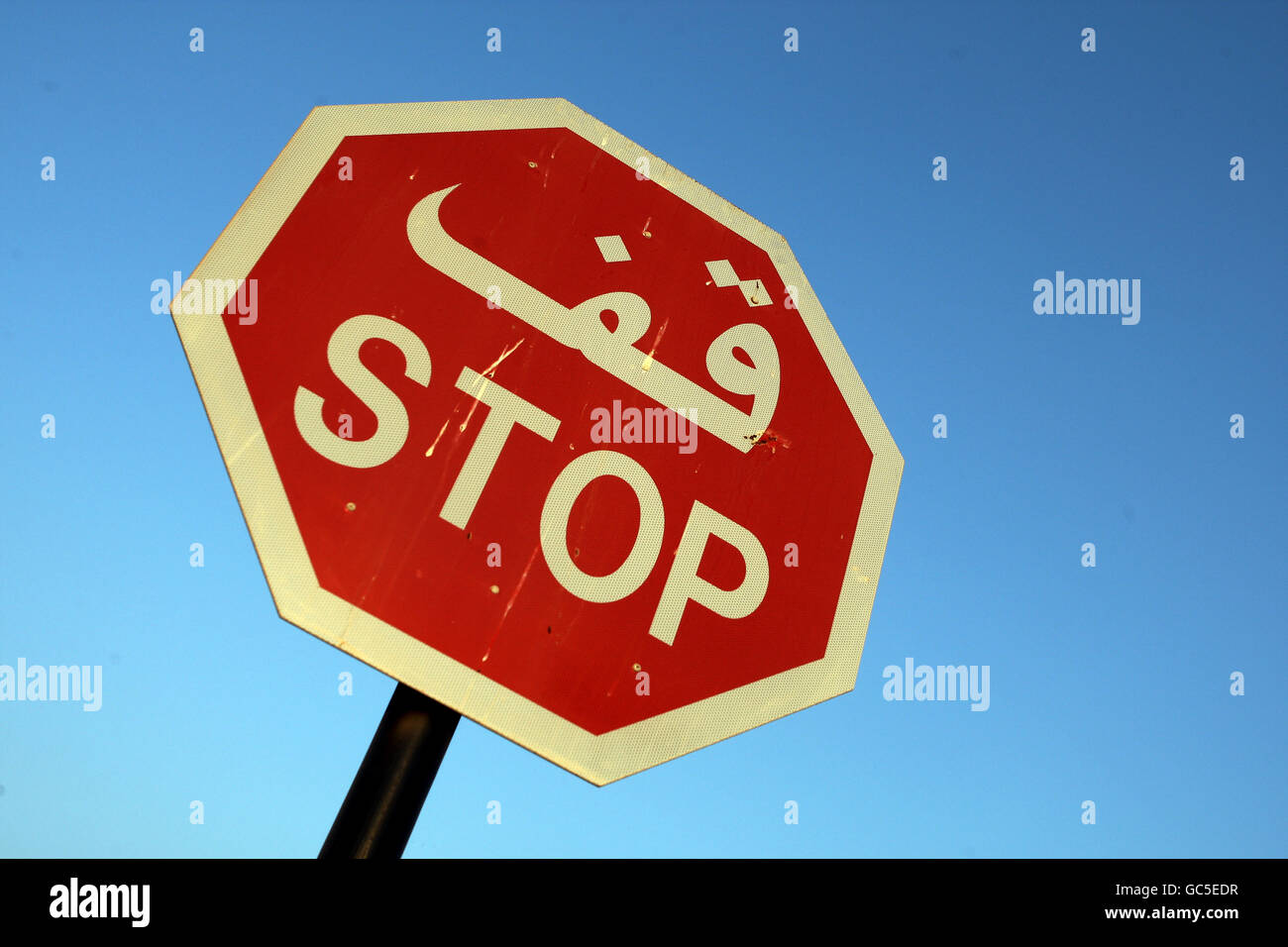 A 'Stop' road sign written in English and Arabic in Abu Dhabi, United ...