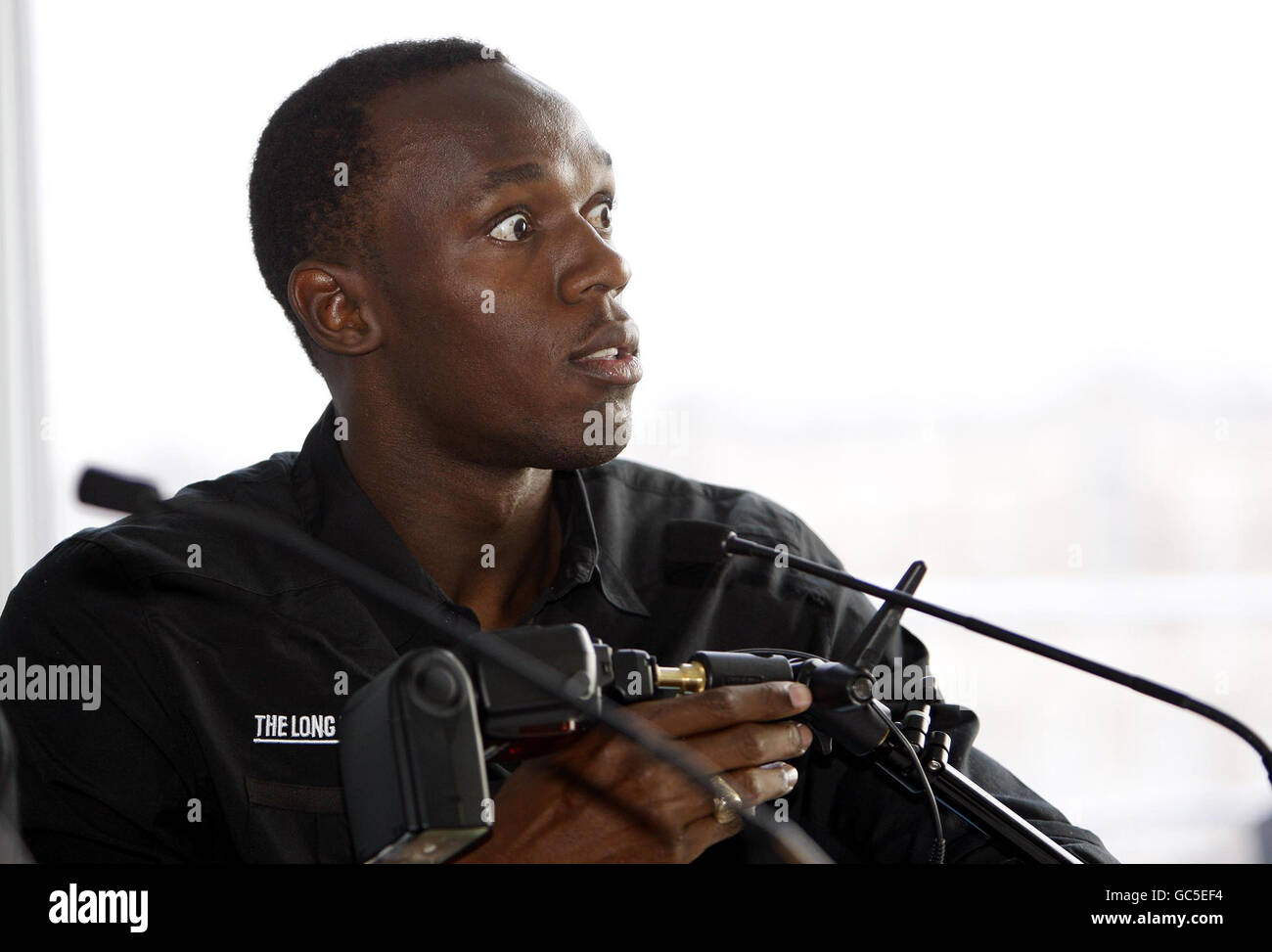 A photographer's flash stand falls on Usain Bolt during the photocall ...