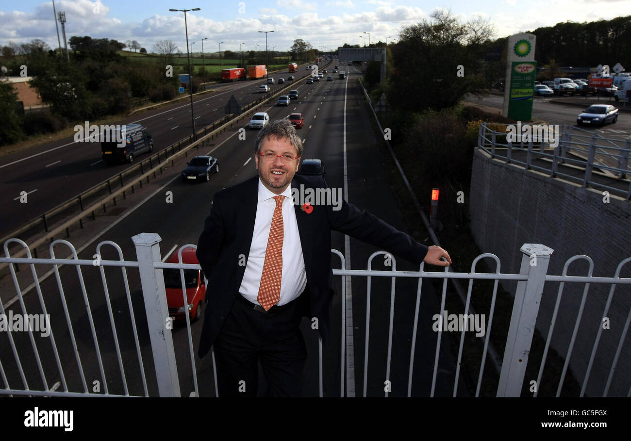 Raods Minister Chris Mole stands on a footbridge over the M1 motorway ...