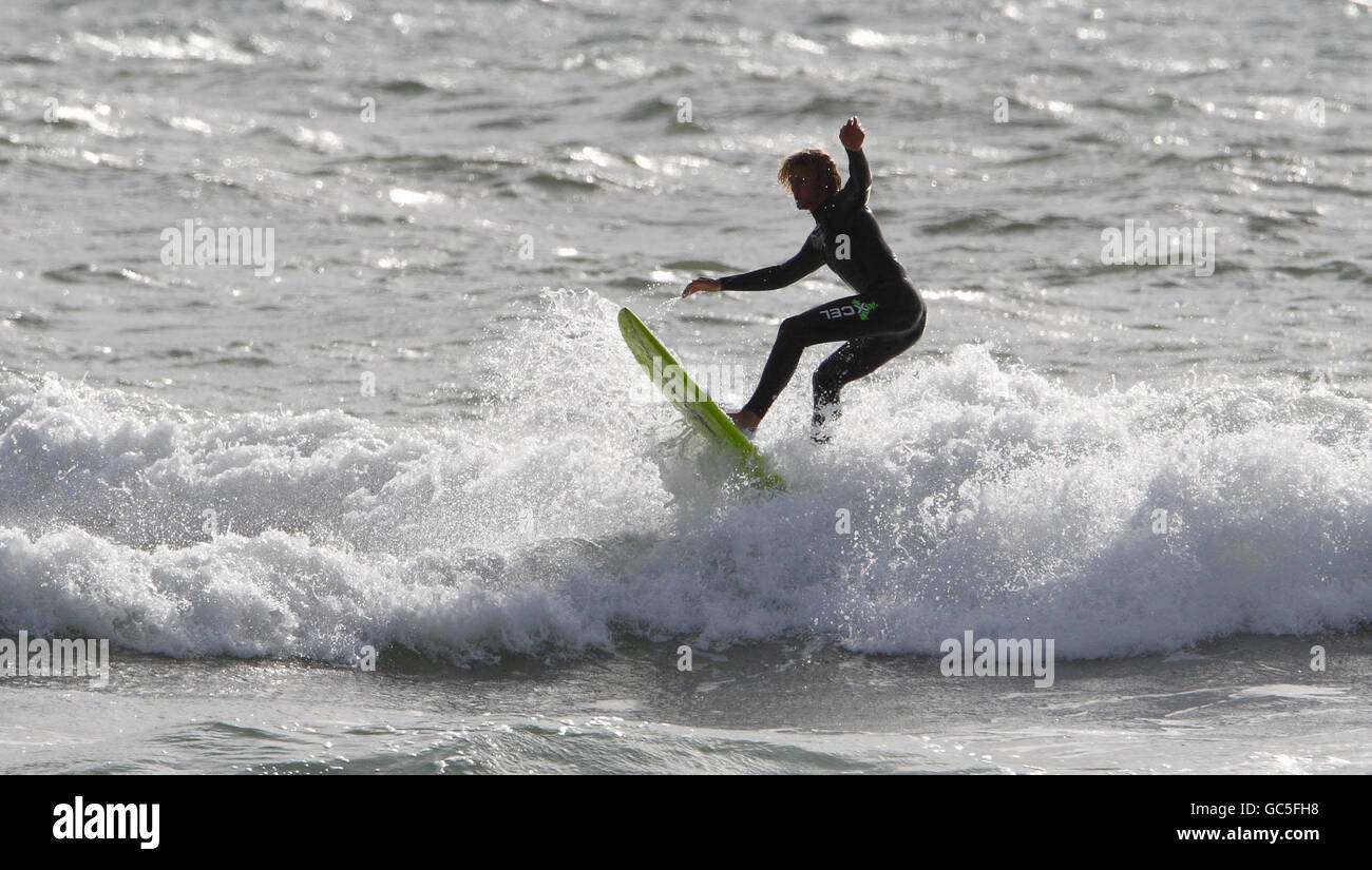 A surfer catches a wave generated from the new artificial surf reef ...
