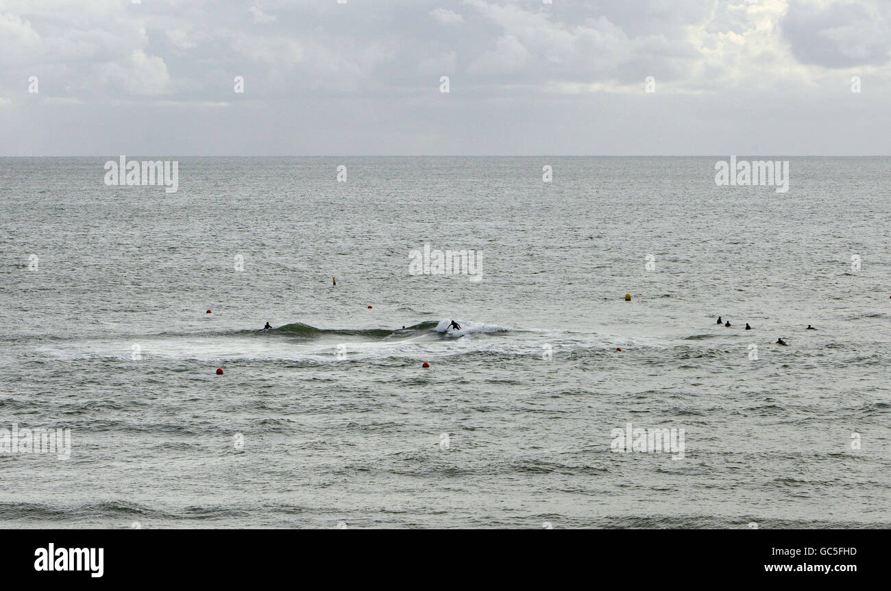 A surfer catches a wave generated from the new artificial surf reef ...