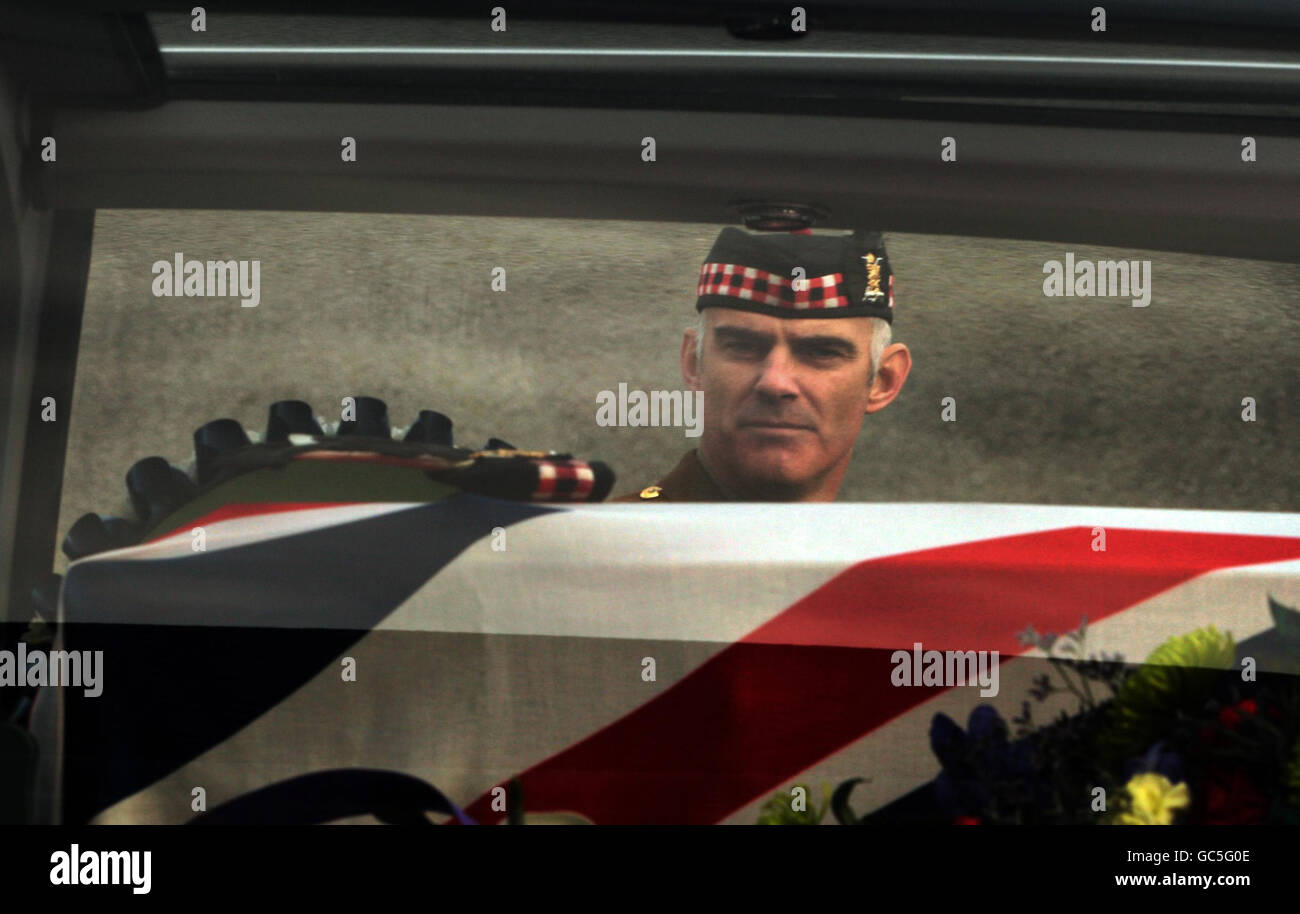 A solider looks at the coffin of Corporal Thomas Mason, who was a ...