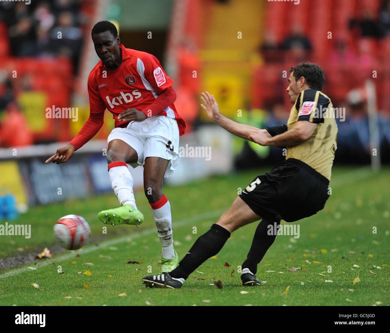 Charlton Athletic's Lloyd Sam (left) gets the ball past Milton Keynes ...