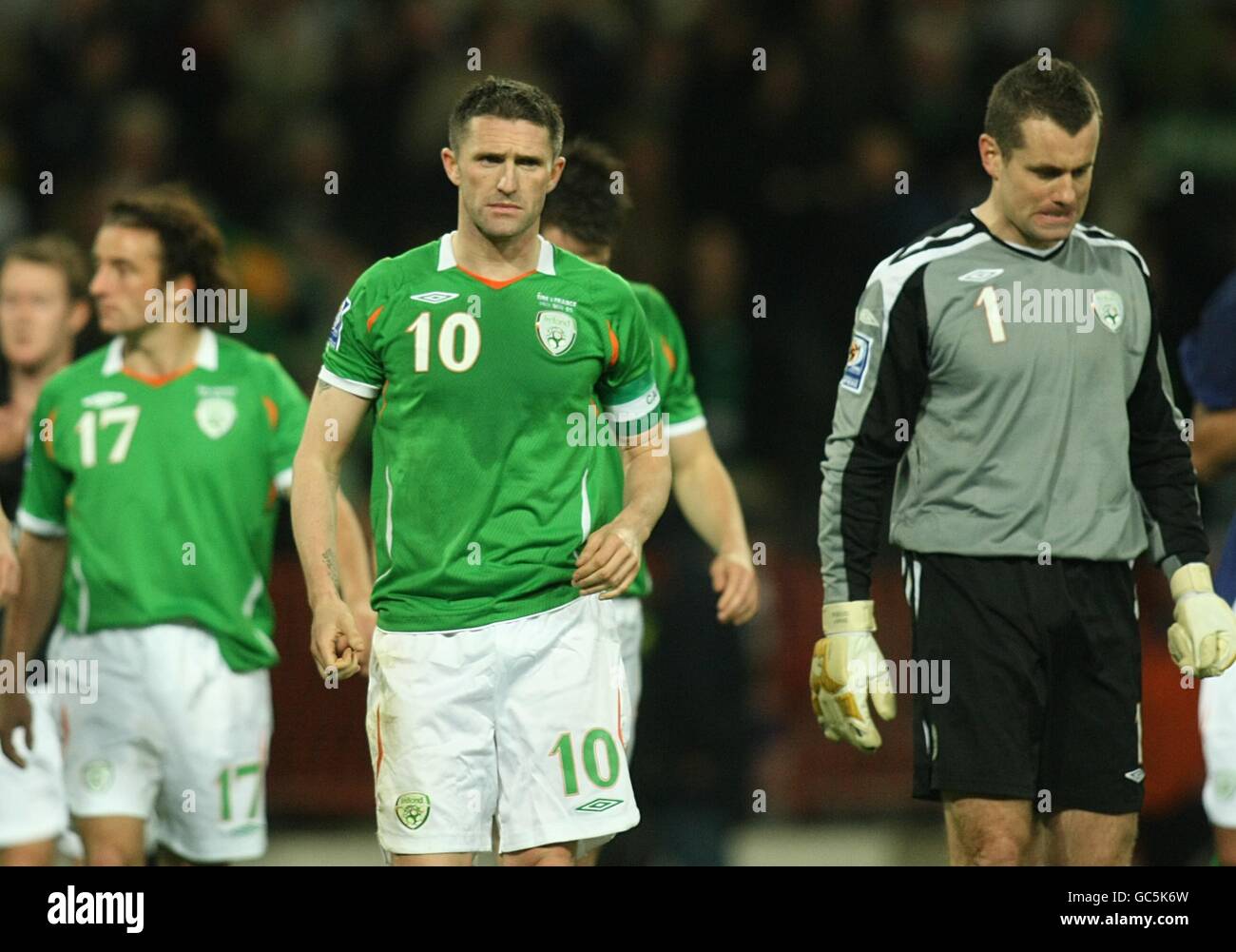 Ireland's Robbie Keane and Shay Given (right) leave the field dejected ...
