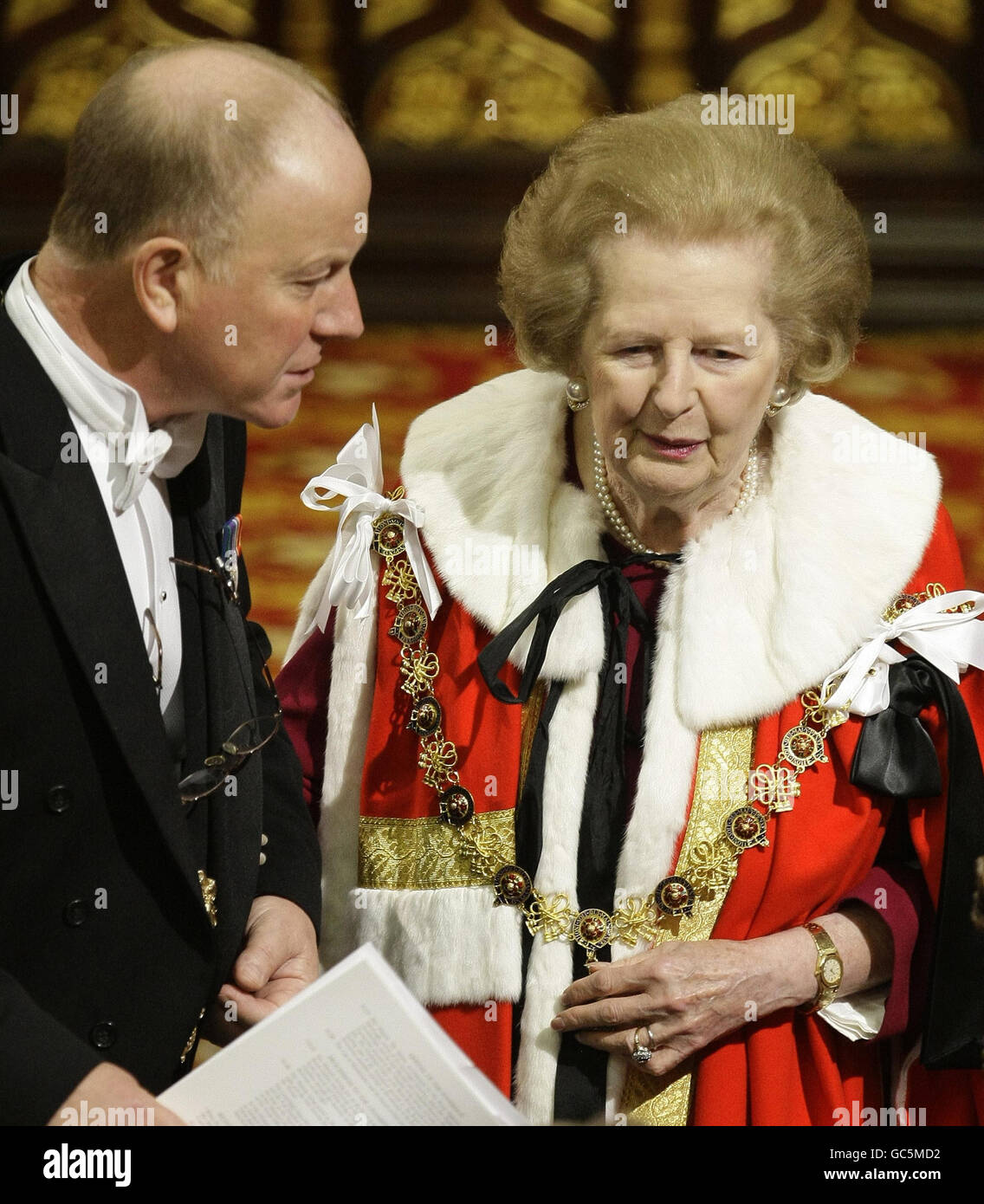 Former British Prime Minister Baroness Thatcher is helped to her seat ...