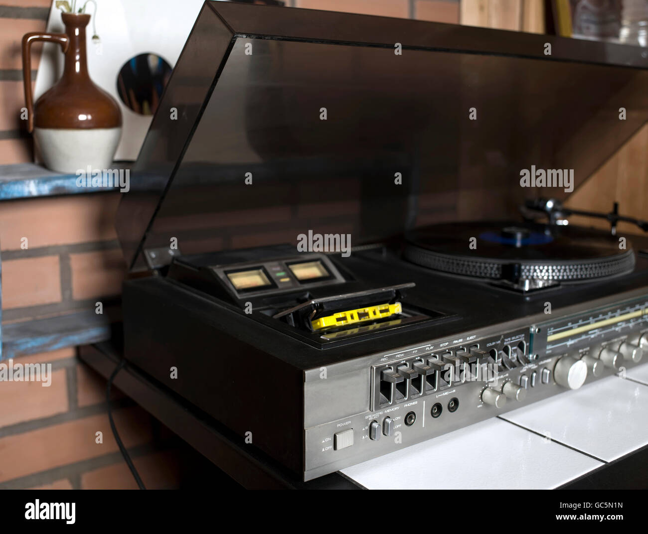Looking retro music stereo center next to the brick wall, angled indoor ...