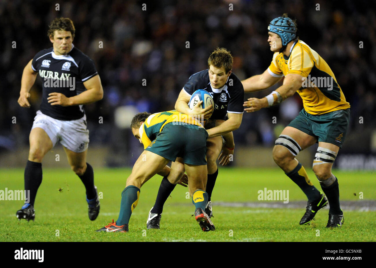 Scotland's Phil Godman (second right) is tackled by Australia's Quade ...