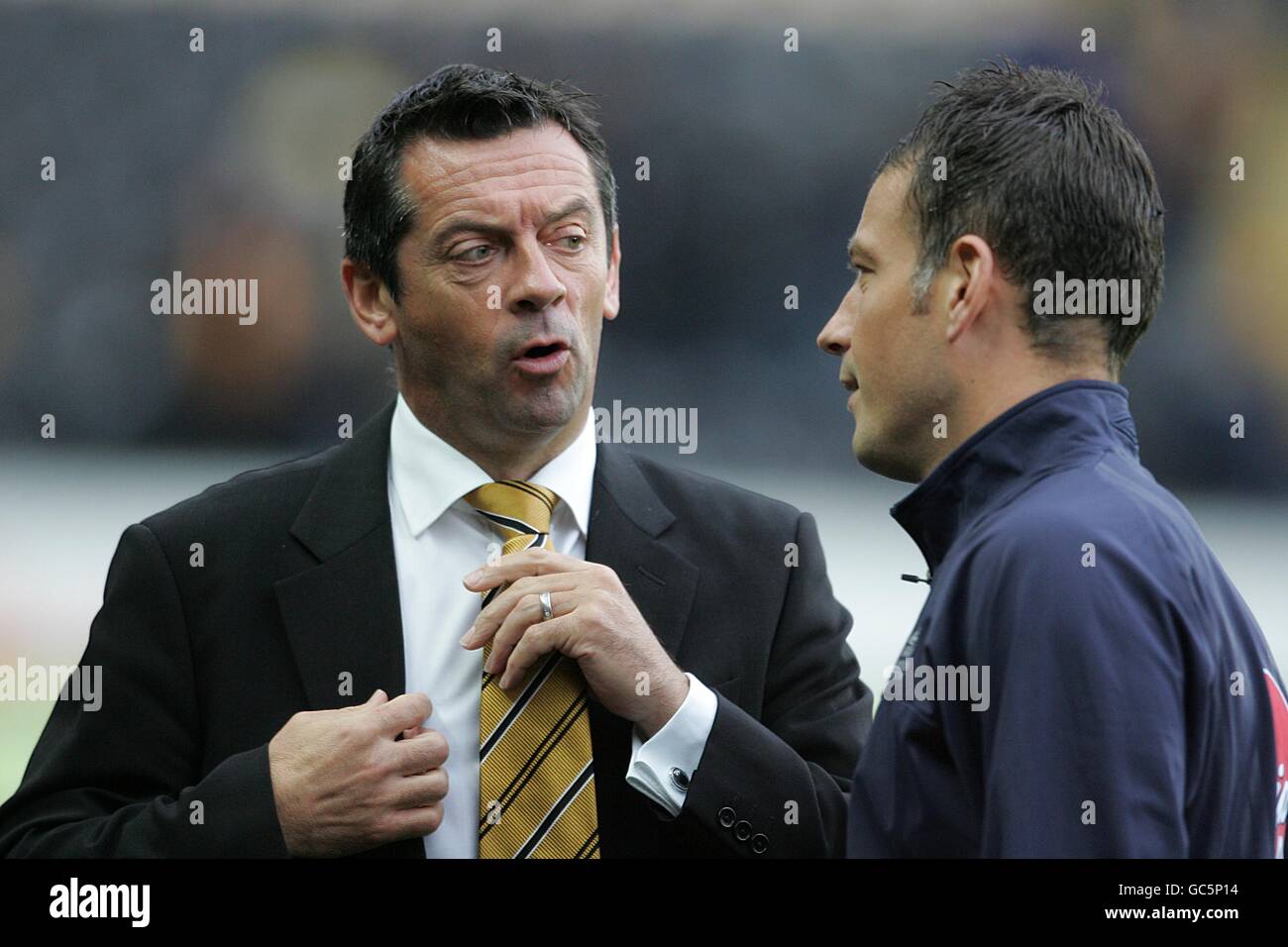 Hull City manager Phil Brown (left) talks with referee Mark Clattenburg ...