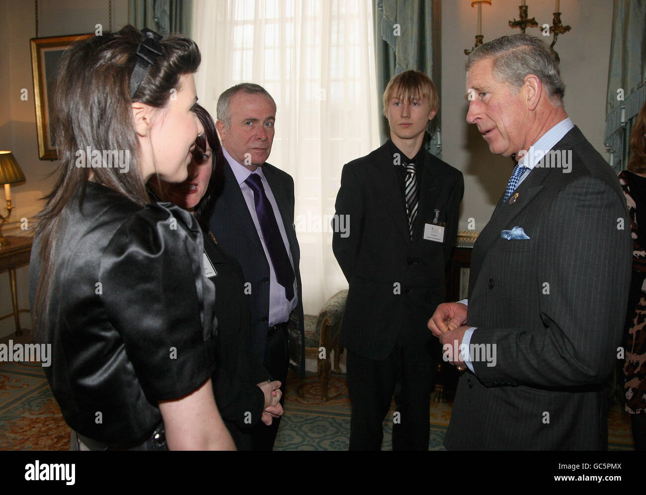 The Prince of Wales poses for a photograph with pupils and teachers ...