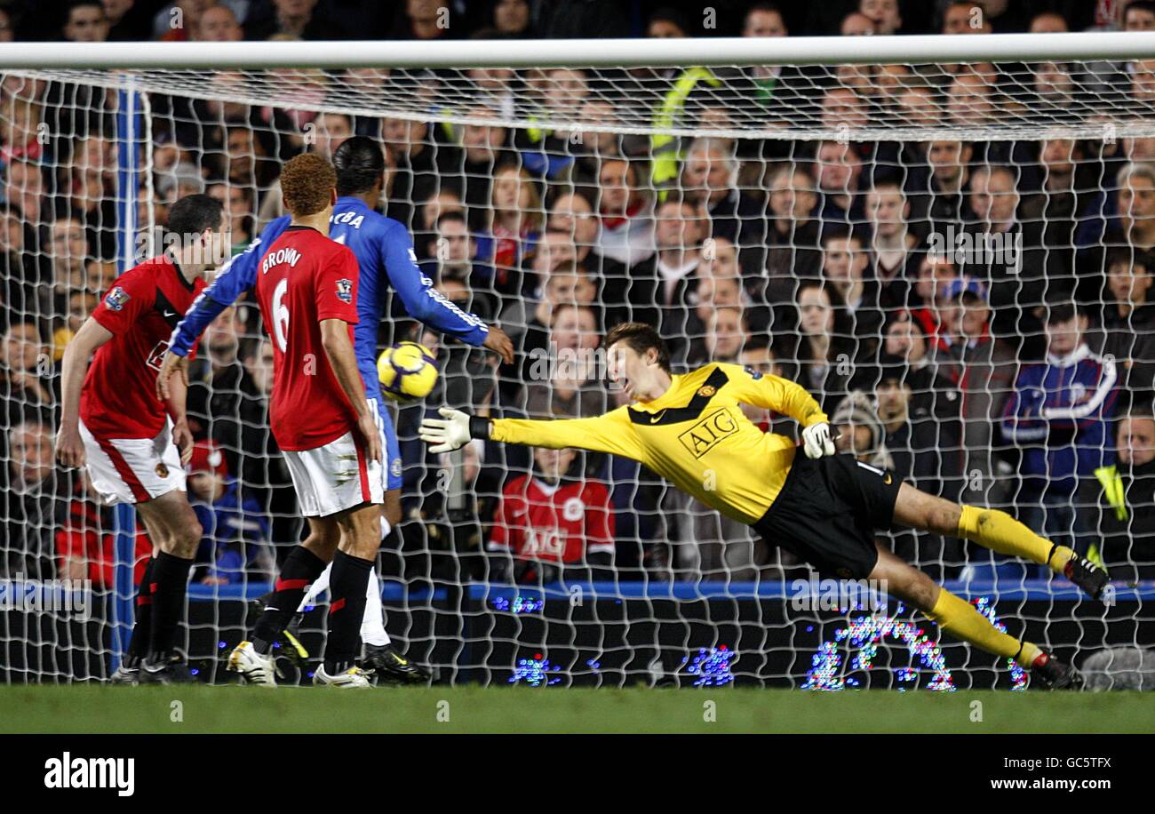 Manchester United goalkeeper Edwin Van der Sar dives to his right to ...