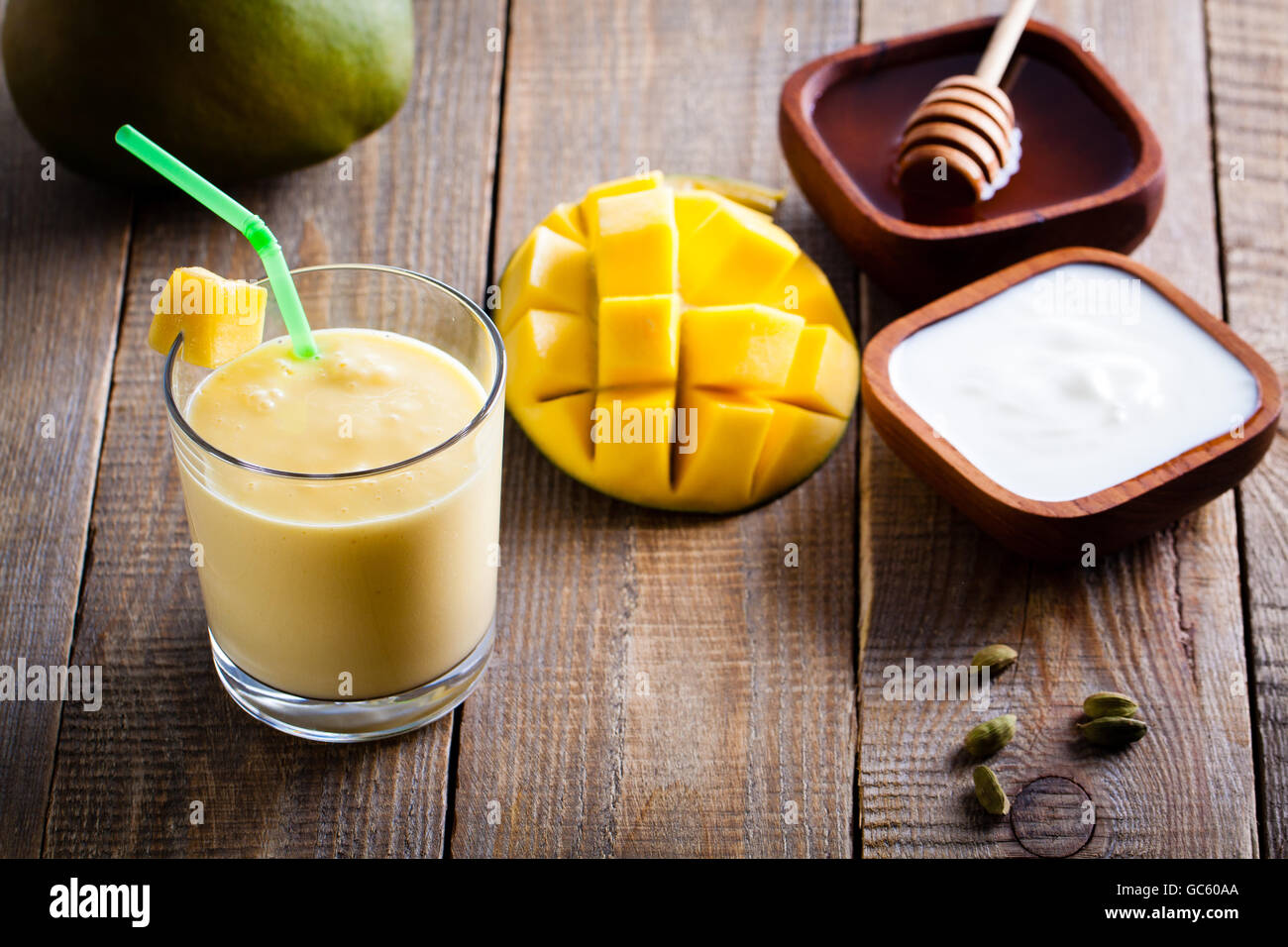 Glass of mango lassi, Indian drink made from yogurt with blended mango ...