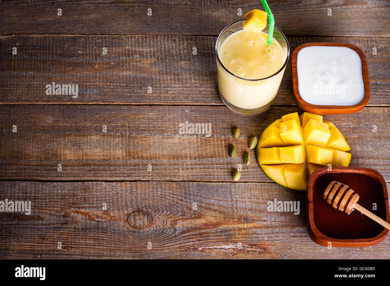 Top view of glass milkshake with mango, yoghurt and honey with copy ...