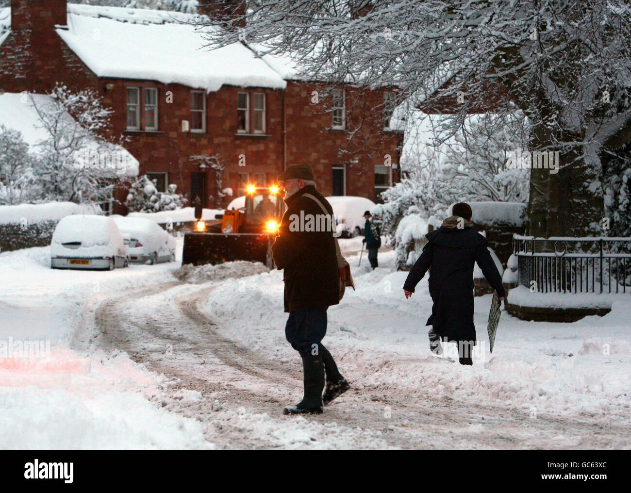A man crosses the road in St Boswells in the Scottish Borders, after a night of heavy snowfall ...