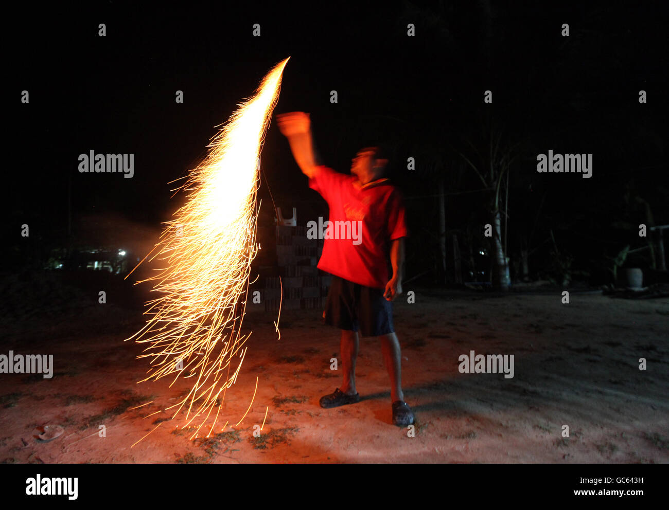 people play with firework near the city of Amnat Charoen in the Region ...