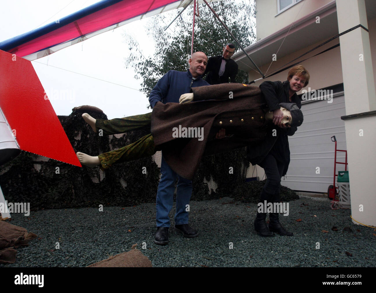 Angie (right) and Simon Mullane carry a James Bond themed mannequin in ...