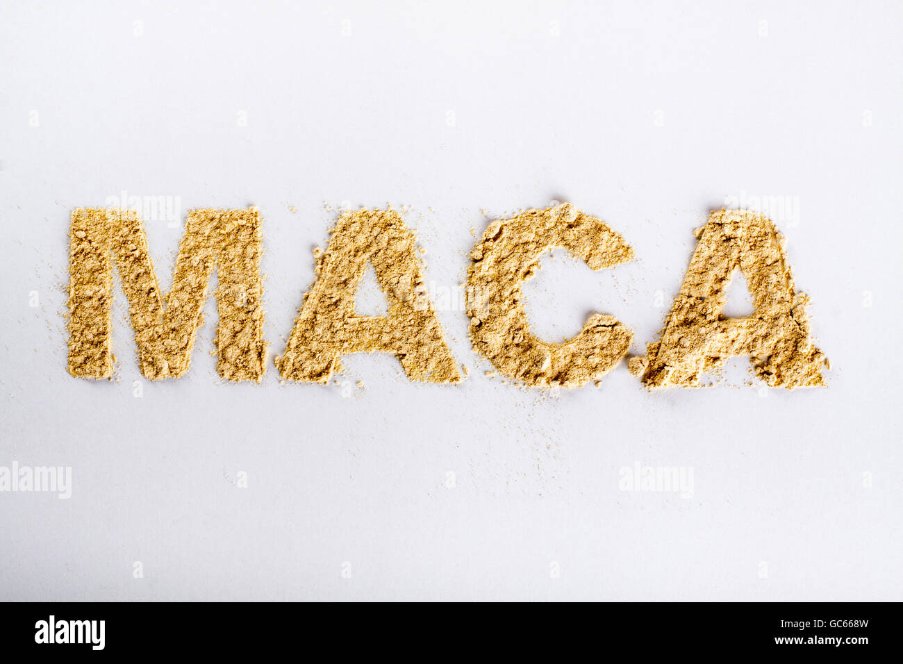 Word maca piled of maca root powder on white background Stock Photo - Alamy