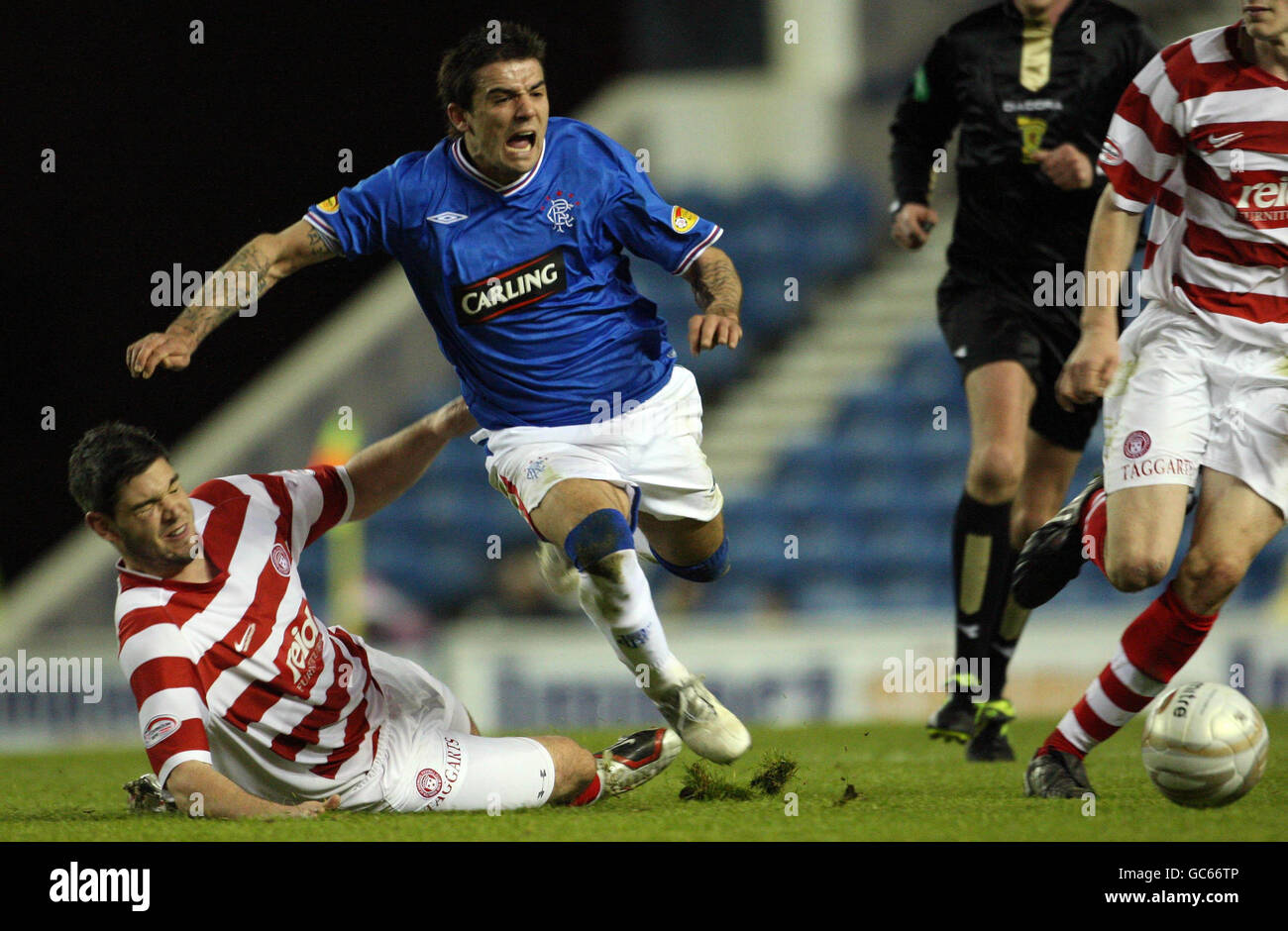 Rangers' Nacho Novo (centre) is caught by Hamilton's David Elbert ...