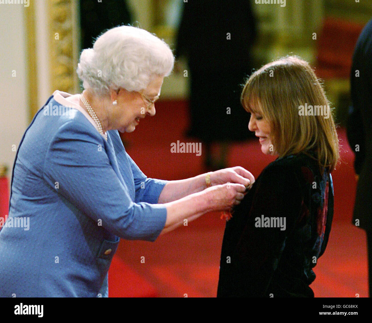 Receives an mbe from the queen at buckingham palace hi-res stock ...