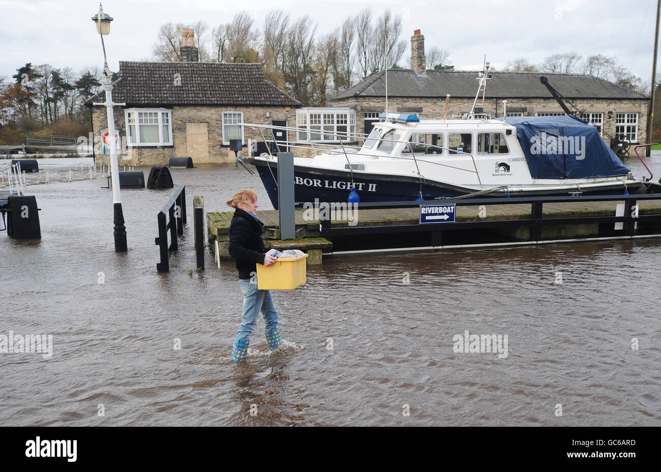 Amy Gaskell carries her shopping home through rising flood waters from ...