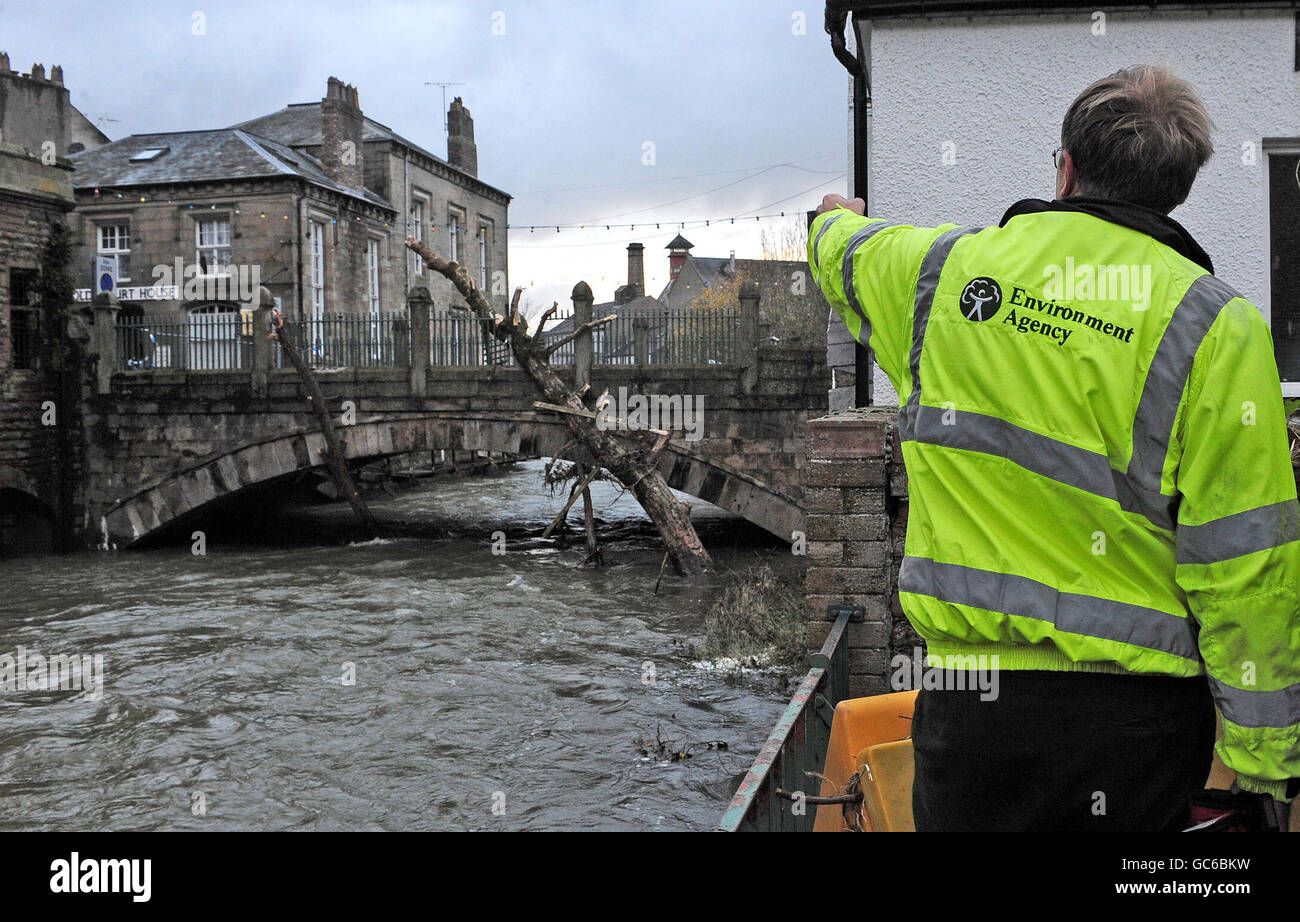 An Environment Agency officer inspecting a scene in Cockermouth where a ...