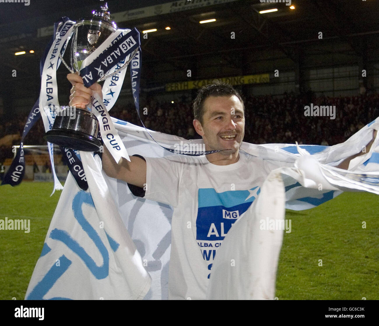 Dundee FC captain Eric Paton holds the Alba Challenge Cup after his ...