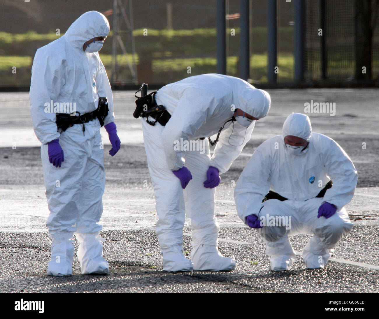 Police forensic officers examine the area around where a car bomb ...