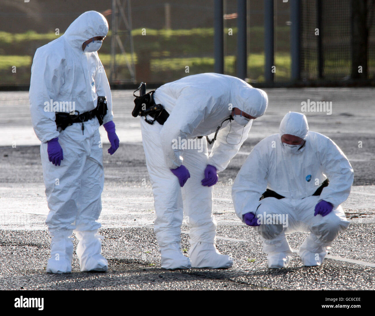 Police forensic officers examine the area around where a car bomb ...
