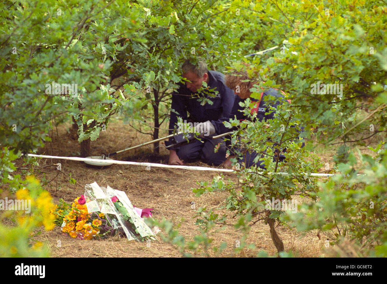 POLICE WITH METAL DETECTORS SEARCH THE WOODLANDS NEAR THE FLOWER MARKED ...