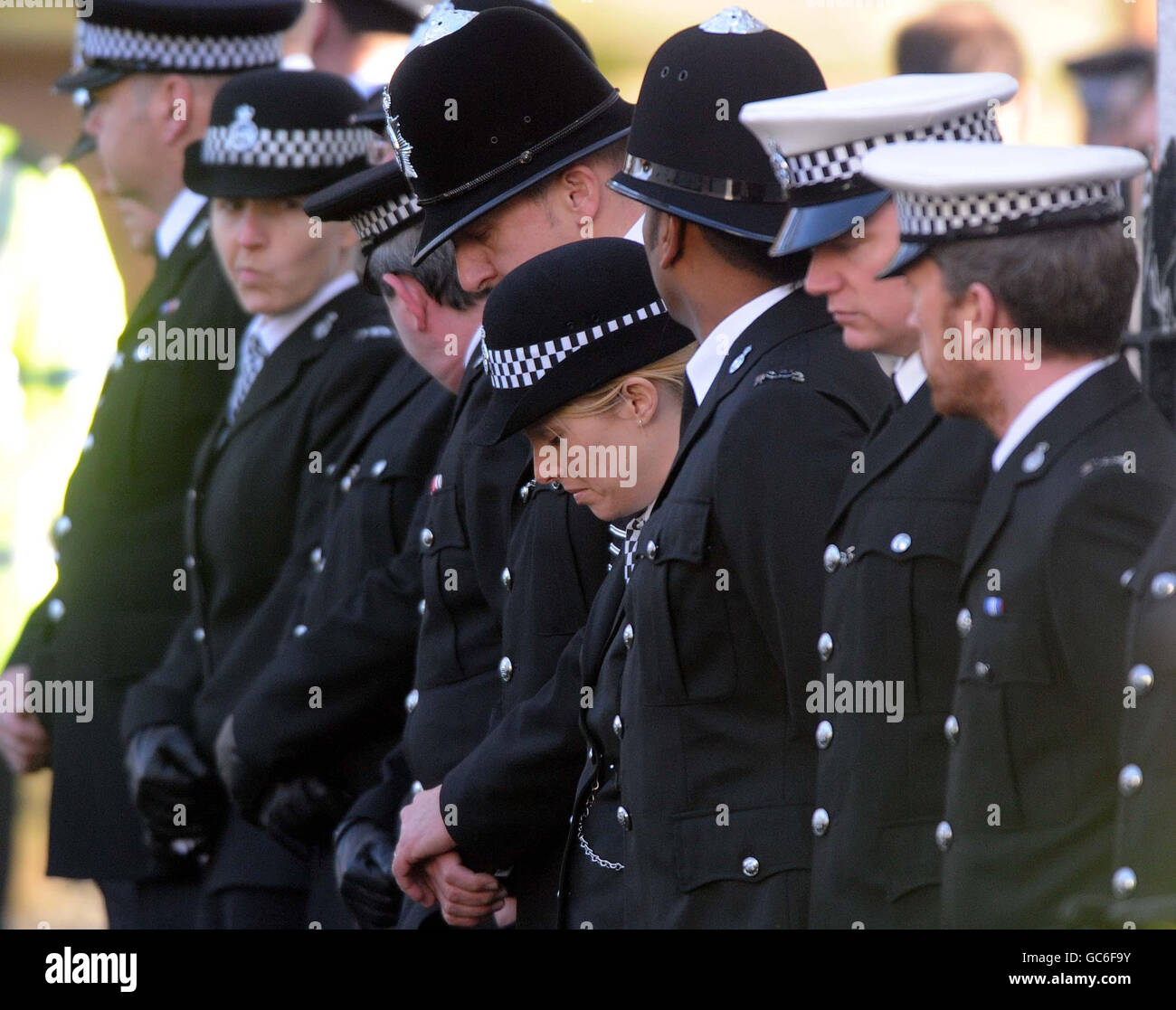 A police guard of honour watches as the coffin of PC Bill Barker ...
