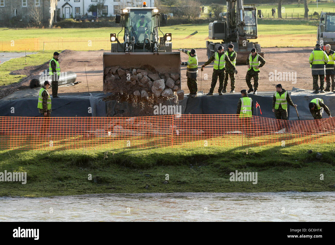 Soldiers work to build a footbridge across the River Derwent, close to ...
