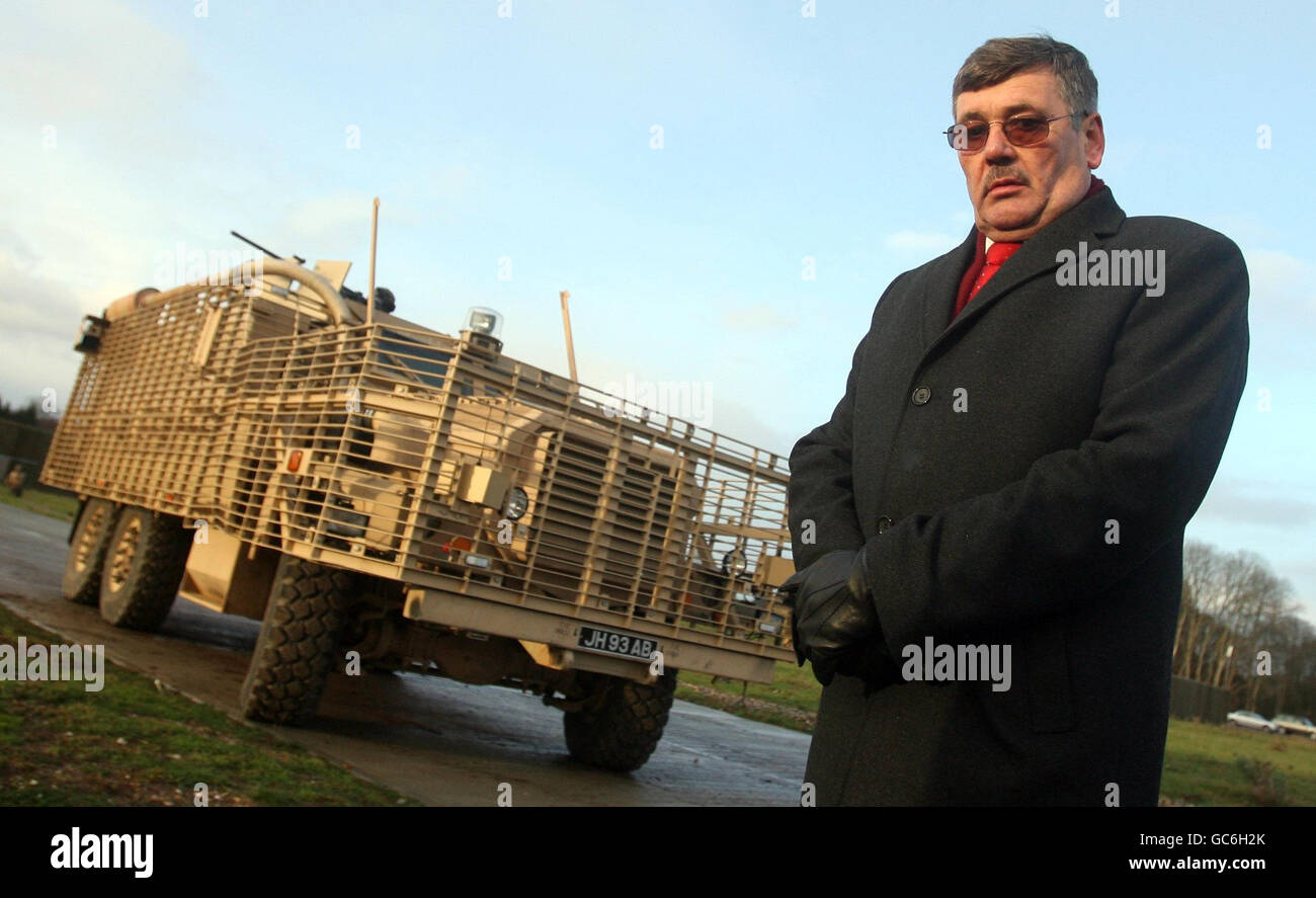 Defence Secretary Bob Ainsworth stands in front of a Mastiff armoured ...